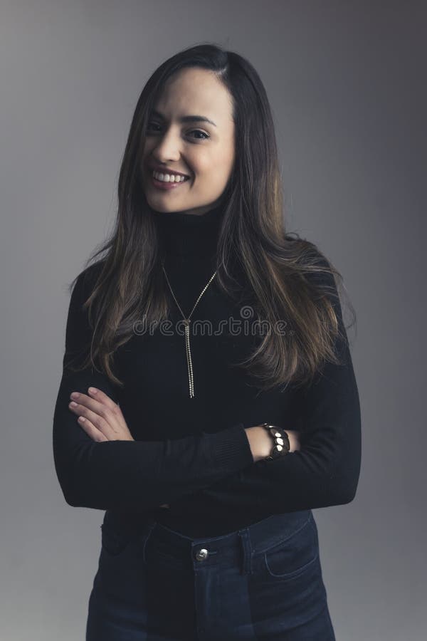 A Medium Shot of Young Brunette Smiling Woman Standing with Arms ... A Medium Shot of Young Brunette Smiling Woman Standing with Arms ...