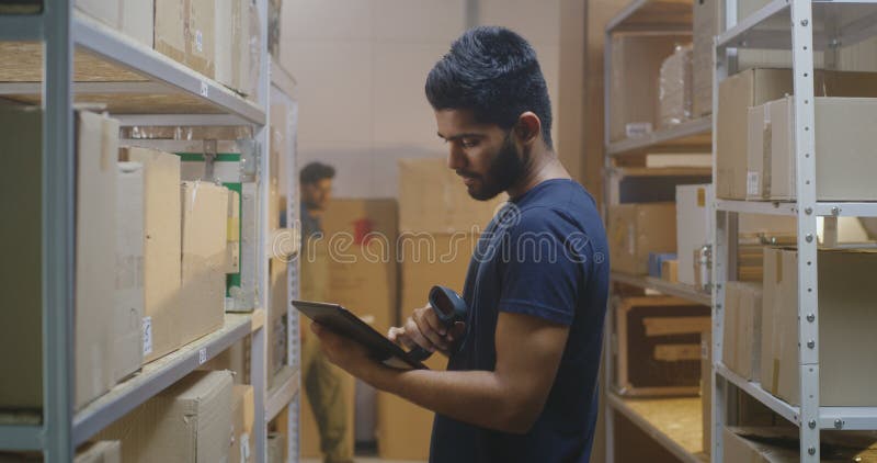 Workers Checking Boxes in a Distribution Center Stock Photo - Image of ...