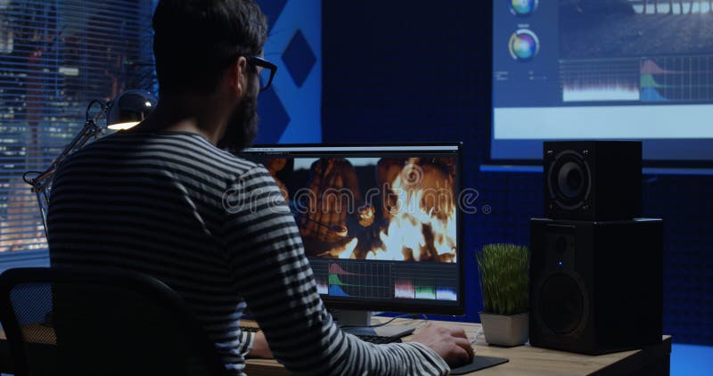 Young Man Sitting Back and Editing Video Inside a Room Stock Image ...