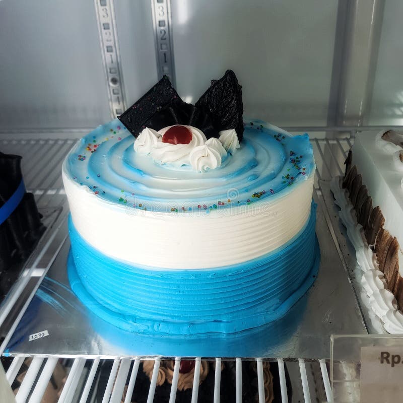 A Medium Size Blue and White Cream Birthday Cake Placed in the ...