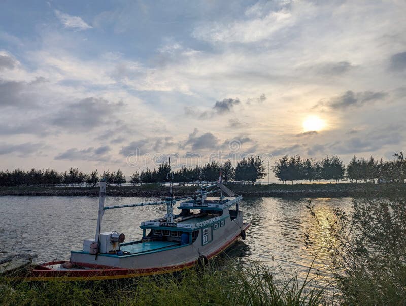 A Medium-sized Fishing Boat Dominates the Center of the Image. the Boat ...
