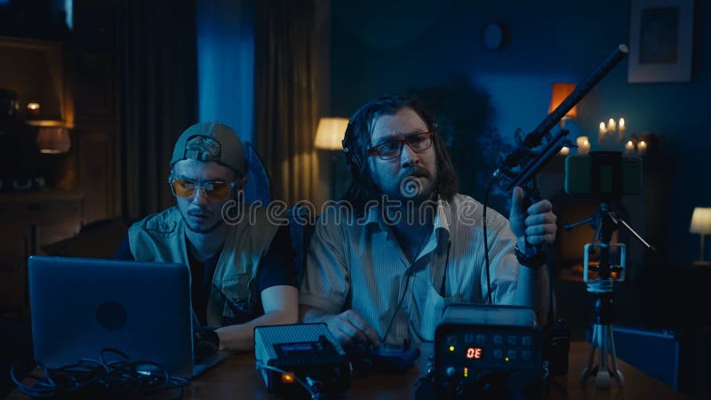 Medium-sized Photo of Two Ghost Hunters Sitting at the Table in a Dark ...