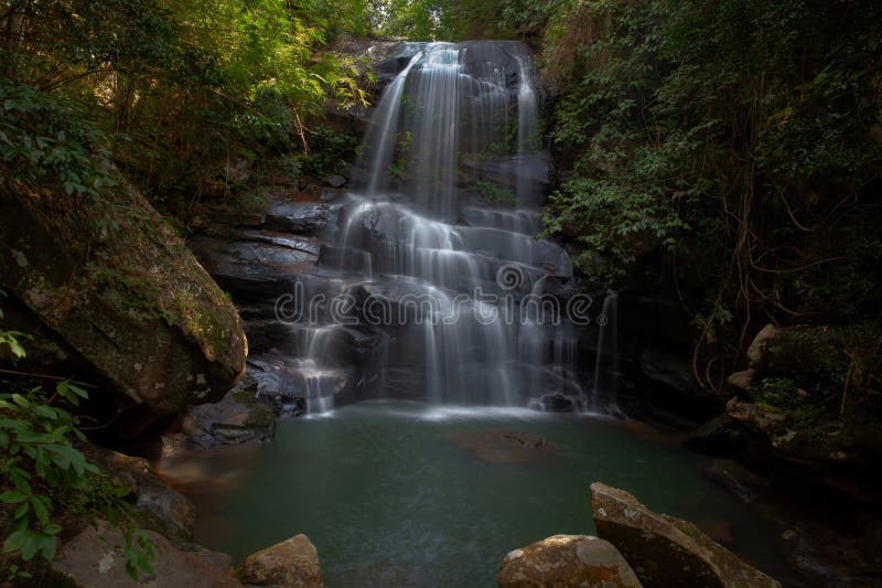 Medium Sized Waterfall among Rocks and Bushes Stock Image - Image of ...