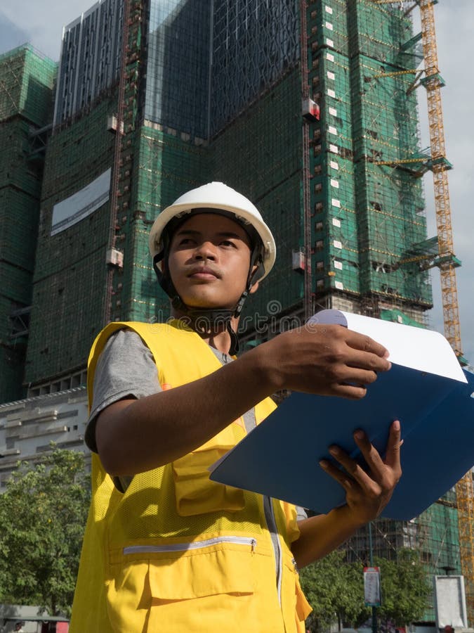 MCU Asian Engineer with Hardhat Seen in 3/4 View, with Construction in ...