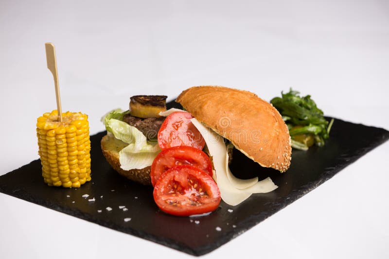 A Meet Burger Served with Cheese and Vegetables Stock Image - Image of ...