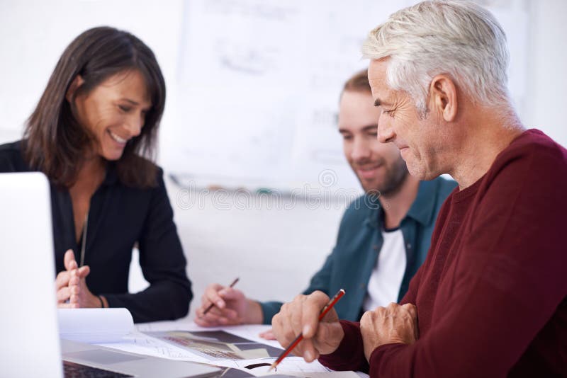 Meeting Client Requirements. Three Architects Working on a New Building ...