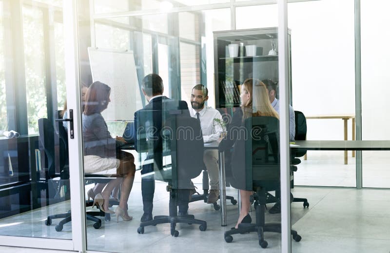 Meeting in Progress. a Team of Executives Having a Formal Meeting in a ...