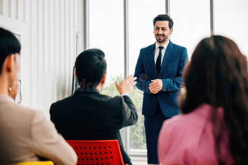 In a Meeting Room, Business Leaders Present Their Insights, while a ... In a Meeting Room, Business Leaders Present Their Insights, while a ...