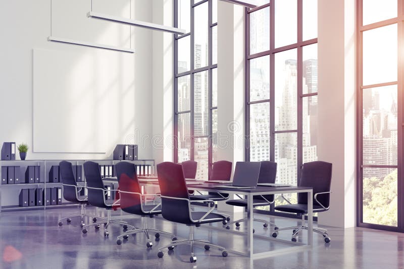 Meeting Room Interior with a Long Black Table with Laptops Standing on ...