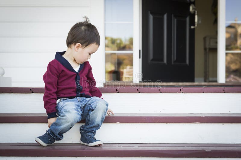 Melancholy Mixed Race Boy Sitting on Front Porch Steps Stock Image ...
