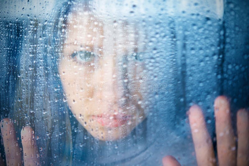 Melancholy and Sad Young Woman at the Window in the Rain Stock Image ...