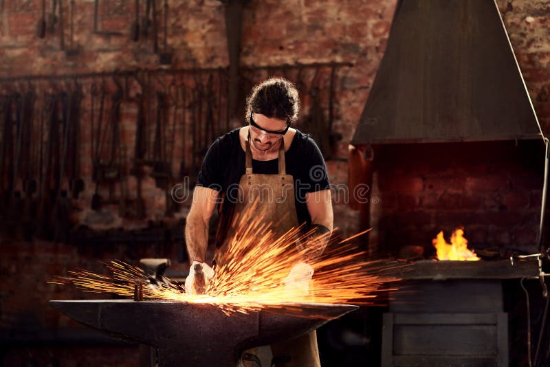 Melt it All Away. a Handsome Young Metal Worker Using a Blowtorch while ...