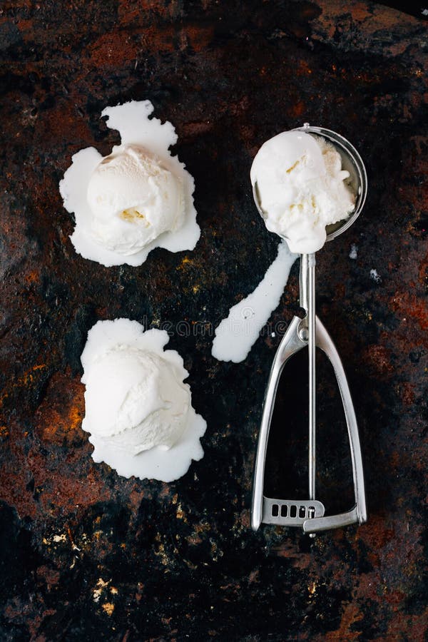 Melted Ice Cream in Metal Ice Cream Scooper Over Black Rustic Table ...