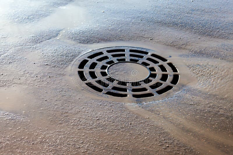 Melted Water Flows Down through the Manhole Cover Stock Image - Image ...