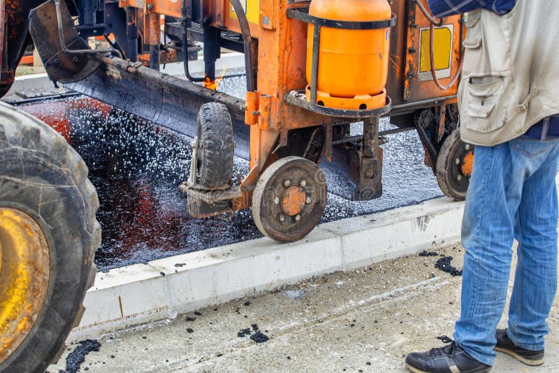 Melting Asphalt with Paver Machine and Placing Gravel Stock Image ...