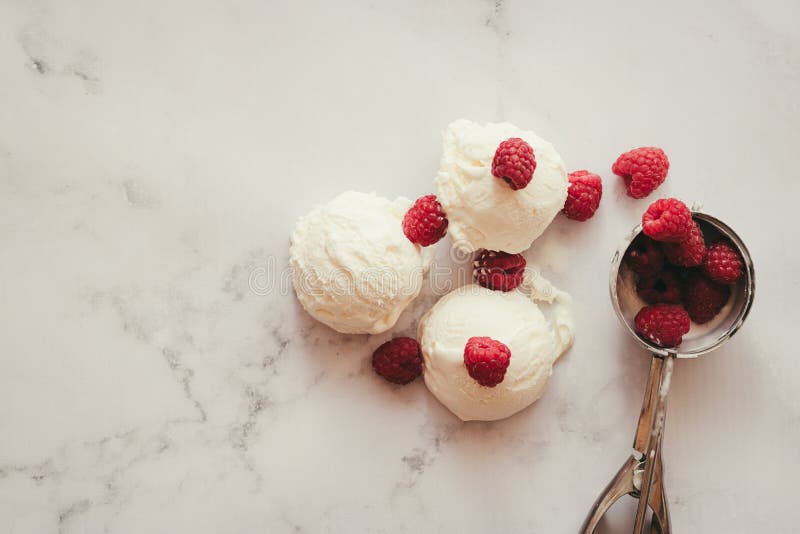 Melting Balls of Vanilla Ice Cream with Raspberries. Stock Photo ...