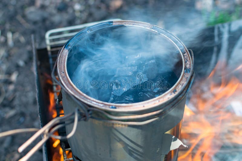 Melting Black Tar Over Fire in a Can of Smoke Stock Image - Image of ...