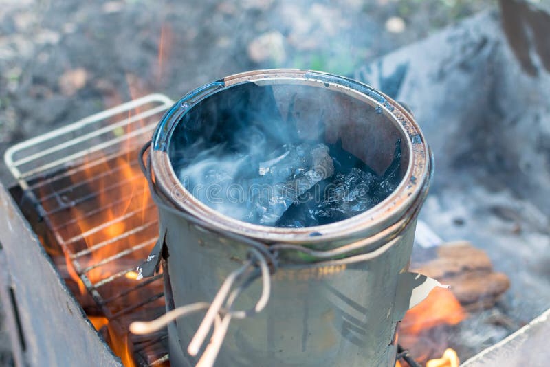 Melting Black Tar Over Fire in Can of Smoke Stock Photo - Image of ...