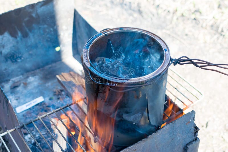 Melting Black Tar Over a Fire in a Can of Smoke Stock Image - Image of ...