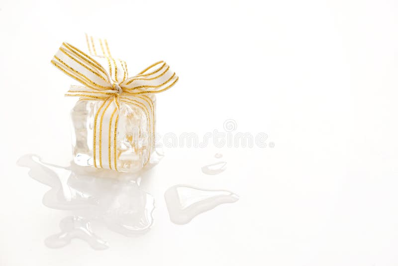 Melting Ice Cube Gift on White Table Stock Image - Image of transparent ...