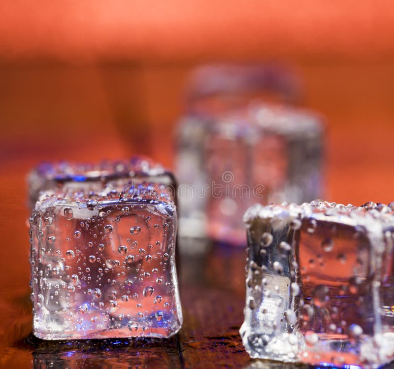 Melting Ice Cubes on a Wooden Table. Close-up Stock Photo - Image of ...