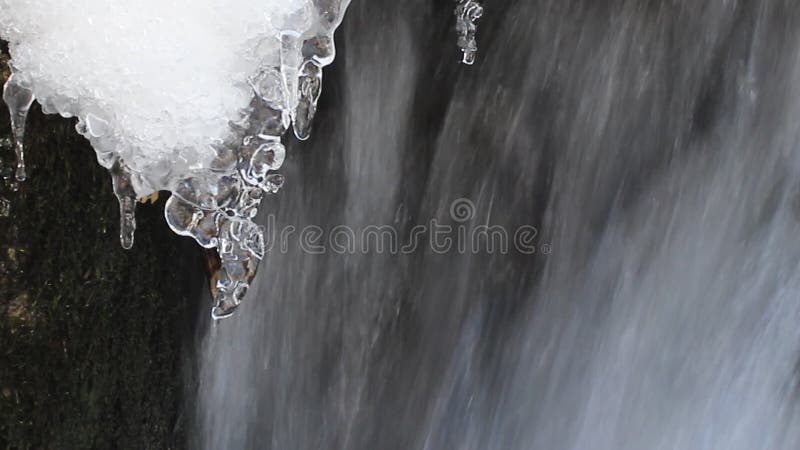 Melting Ice with Dripping Water from Icicles Against a Background of ...
