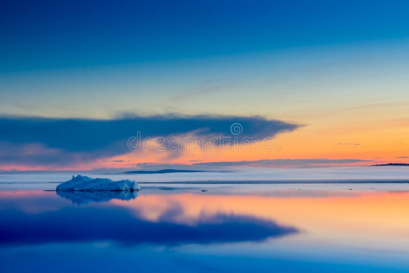 The Melting Iceberg on Spring Mountain Lake in the Setting Sun. Stock ...