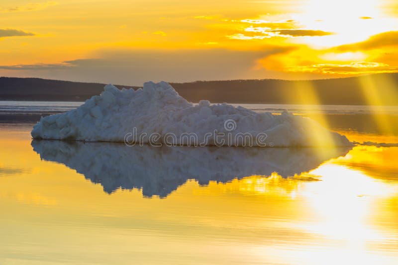 The Melting Iceberg on Spring Mountain Lake in the Setting Sun. Stock ...