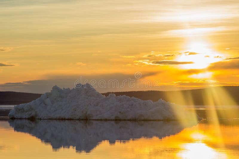 The Melting Iceberg on Spring Mountain Lake in the Setting Sun. Stock ...