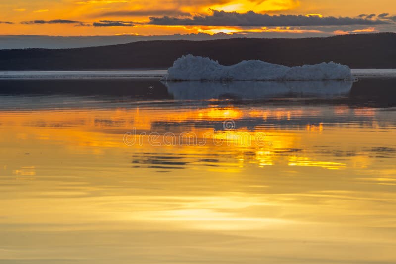 The Melting Iceberg on Spring Mountain Lake in the Setting Sun. Stock ...