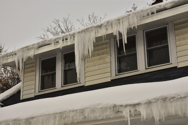 Ice Dam and Icicles in Roof Gutter of Home. Stock Image - Image of ...