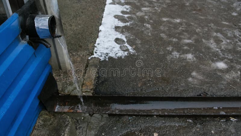 Meltwater Flows through a Storm Drain Pipe . Concept of the Onset of ...