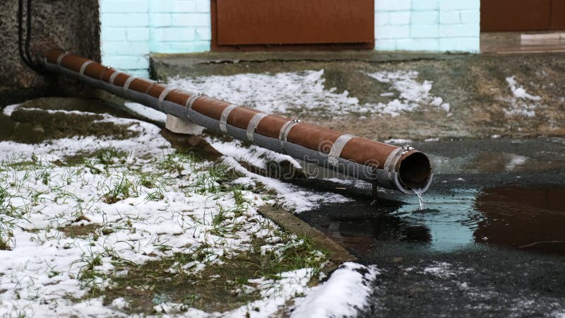 Meltwater Flows through a Storm Drain Pipe . Concept of the Onset of ...