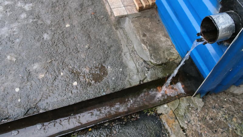 Meltwater Flows through a Storm Drain Pipe . Concept of the Onset of ...