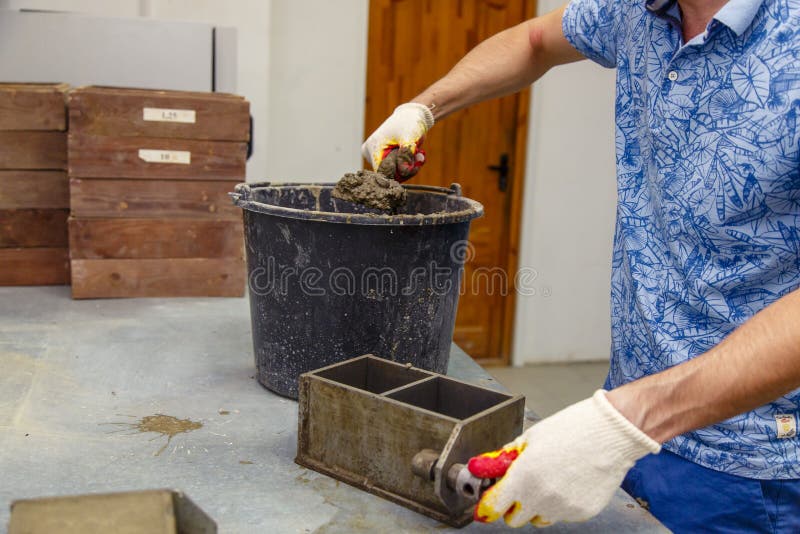 A Member of the Construction of the Laboratory Takes a Sample of ...