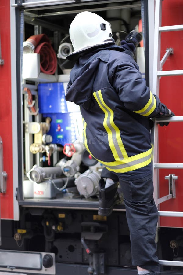 A Member of the Fire Brigade Holds a Water Supply Hose Editorial Image ...