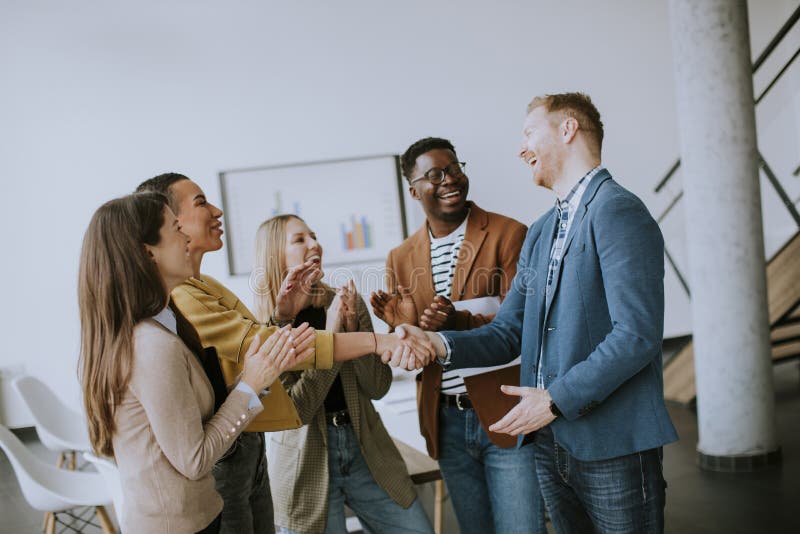 Memembers of Creative Team Shaking Hands while Working in the Modern ...