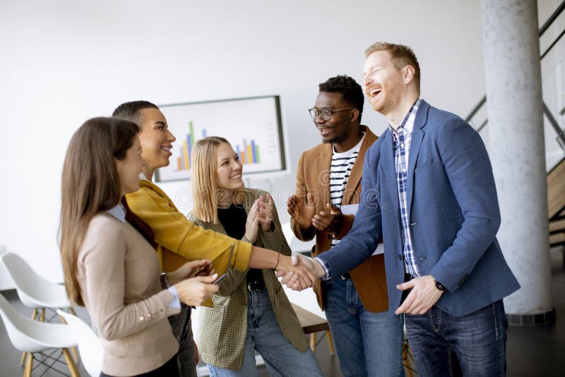 Memembers of Creative Team Shaking Hands while Working in the Modern ...