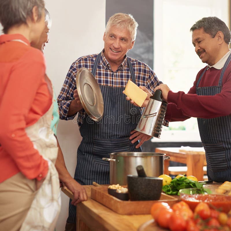 Memories are Homemade. a Group of Seniors Cooking in the Kitchen. Stock ...