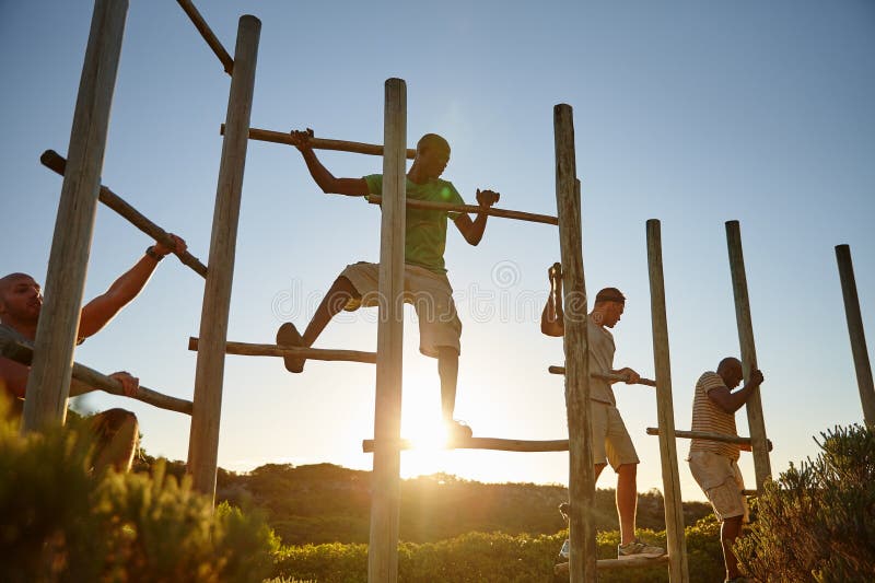 Men of Action. a Group of Men Going through an Obstacle Course at ...