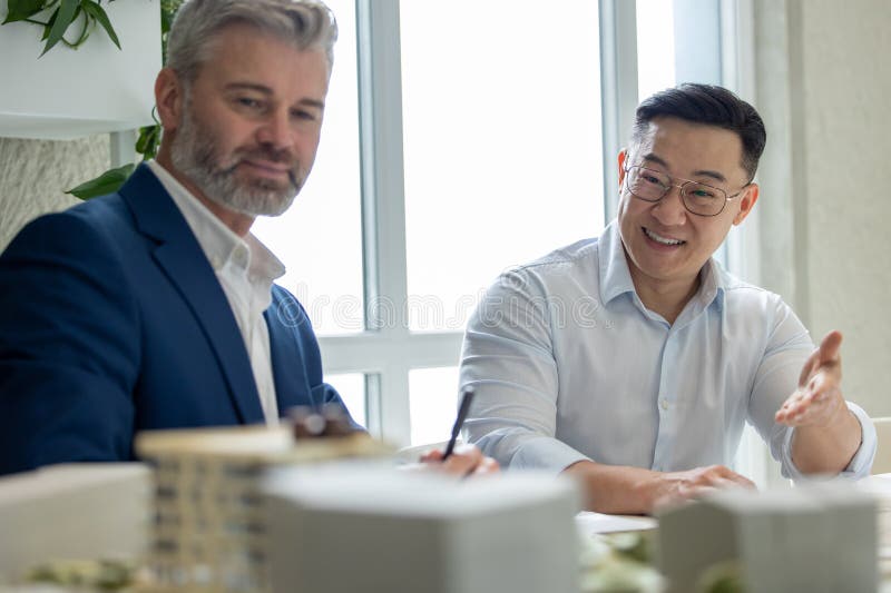 Men Architects Working on Construction Plans, Engineers Discussing on ...