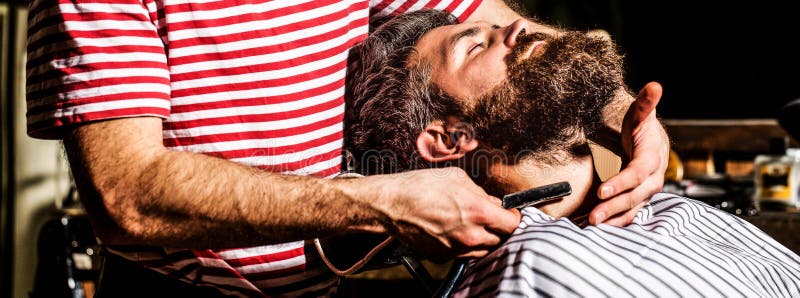 Men Barber Shaves His Beard. Bearded Male Sitting in an Armchair in a ... Men Barber Shaves His Beard. Bearded Male Sitting in an Armchair in a ...