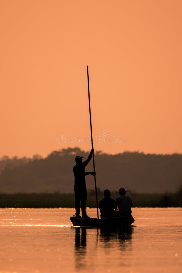 Men in a Boat on a River Silhouette Stock Photo - Image of inundation ...