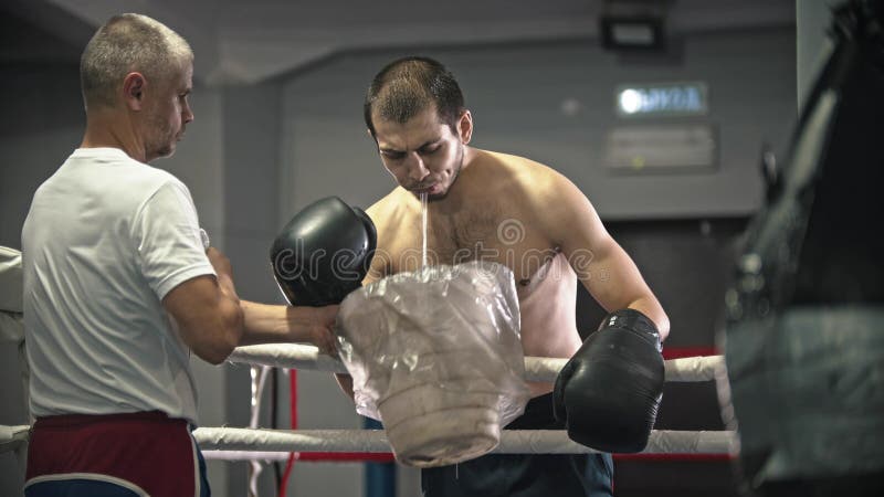 A Man Boxer Spits Out Water in the Bin Stock Photo - Image of rope ...