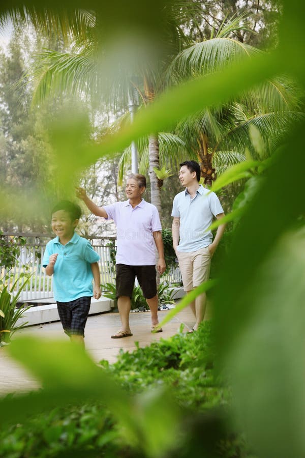 Men and Boy Taking a Stroll Down the Promenade. Conceptual Image Stock ...