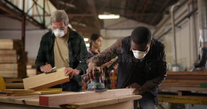 Men, Carpenter and Sanding Woodwork in Workshop with Machine for ...