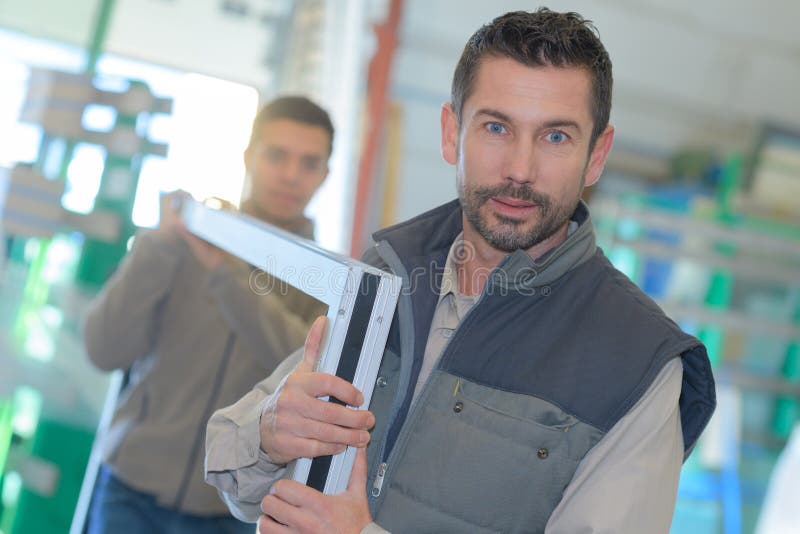 Construction Workers Carrying Window Glass Stock Image - Image of ...