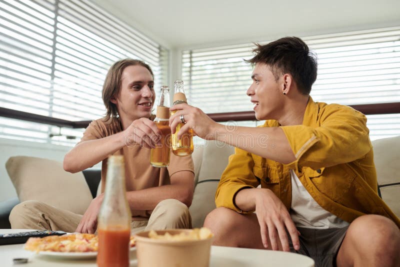 Men Clinking Beer at Home stock photo. Image of clinking - 264487548