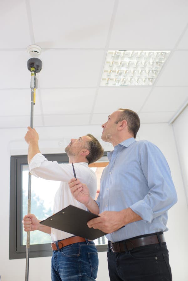 Man Controlling Fire Detectors Stock Photo - Image of install, checking ...
