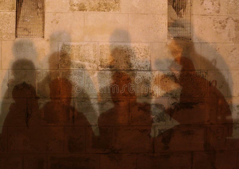 Men Conversing in the Shade of Stone Wall Background Stock Photo ...